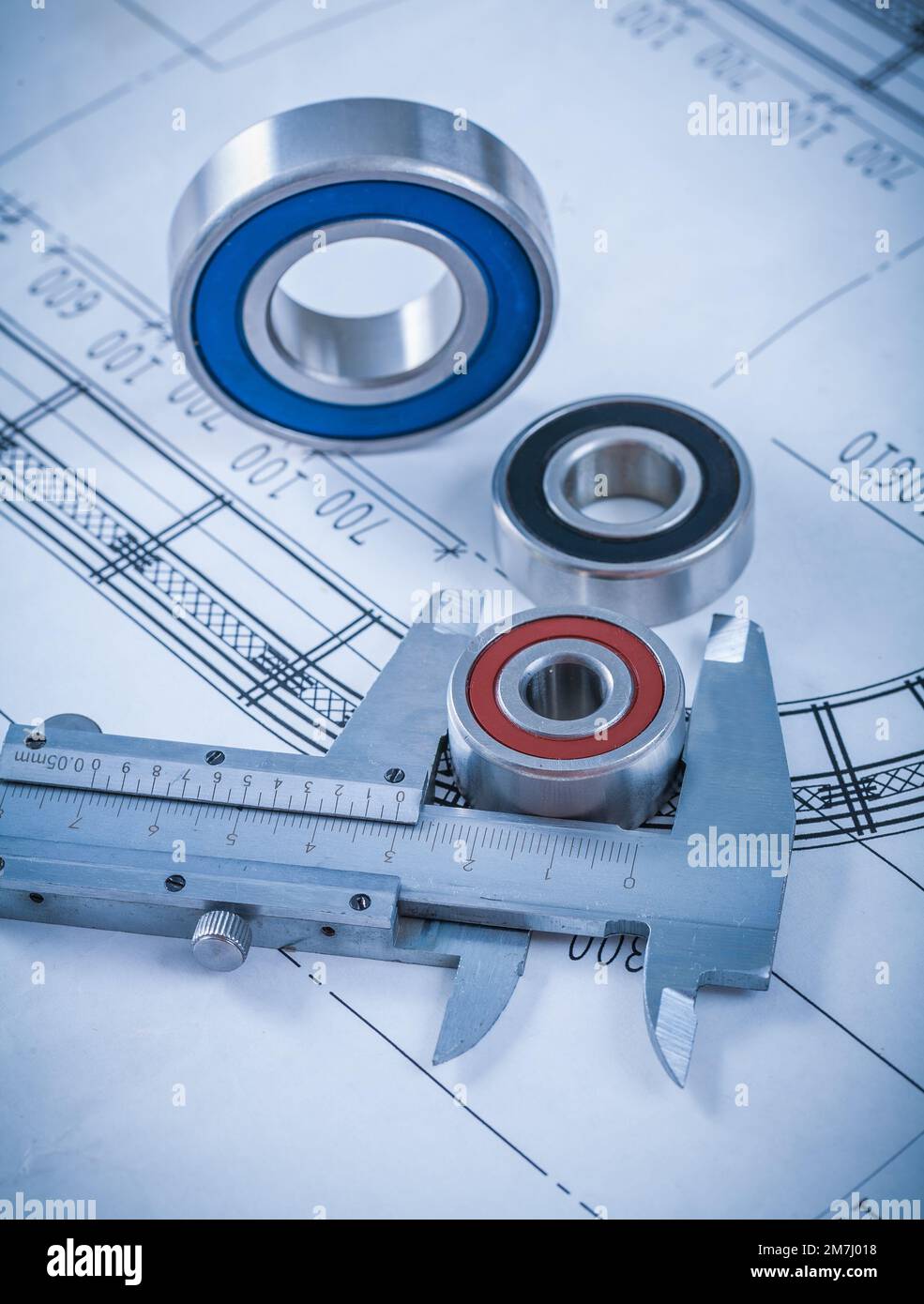 Metal rolling bearings and slide caliper on blueprint construction ...