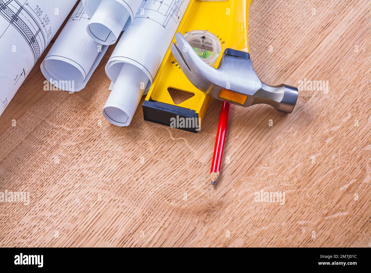 level hammer pencil and rolls of blueprints construction concept Stock ...