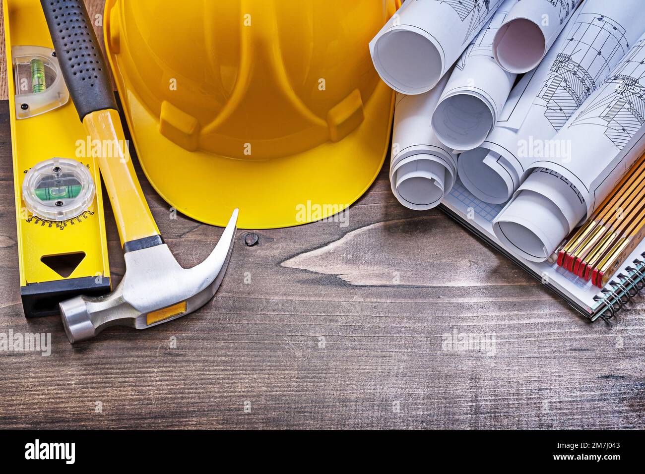 Notepad blueprints construction hat claw hammer wooden meter and ...