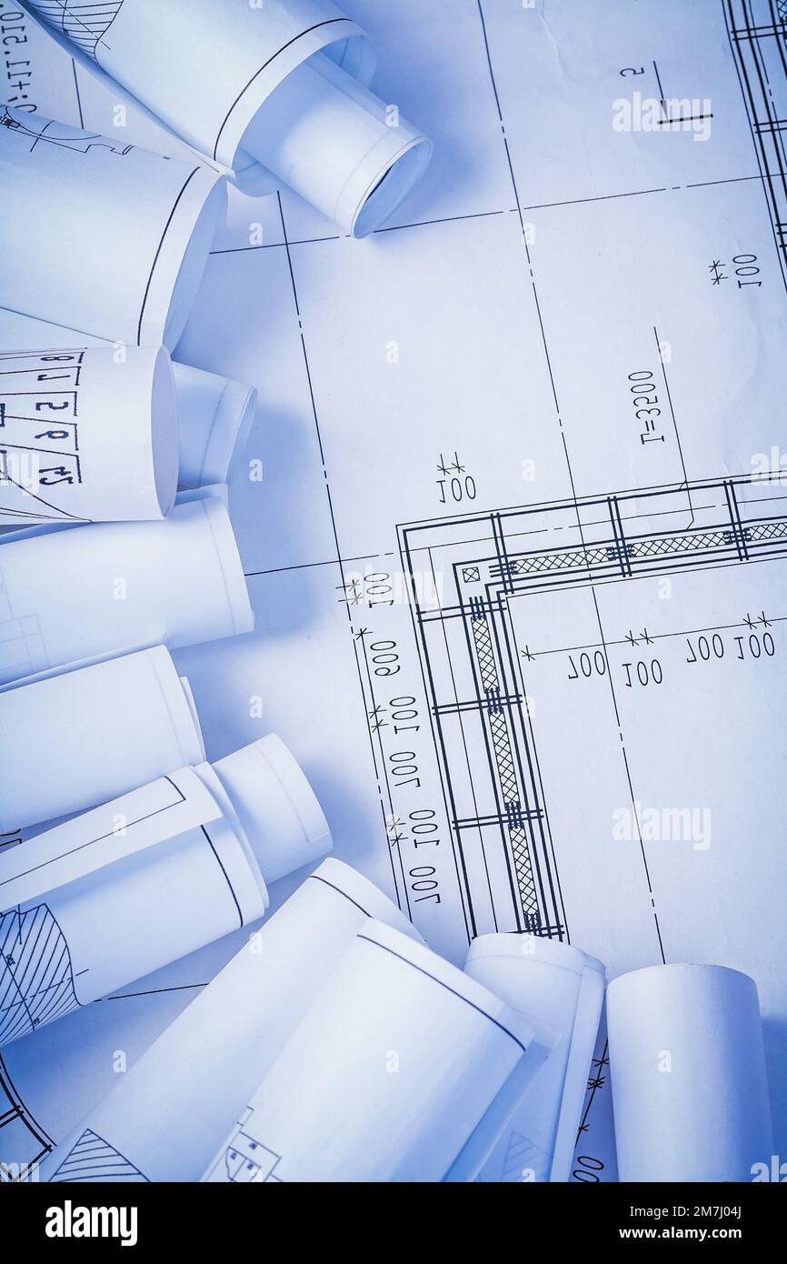 organized copyspace of architect working place with rolled blueprints ...