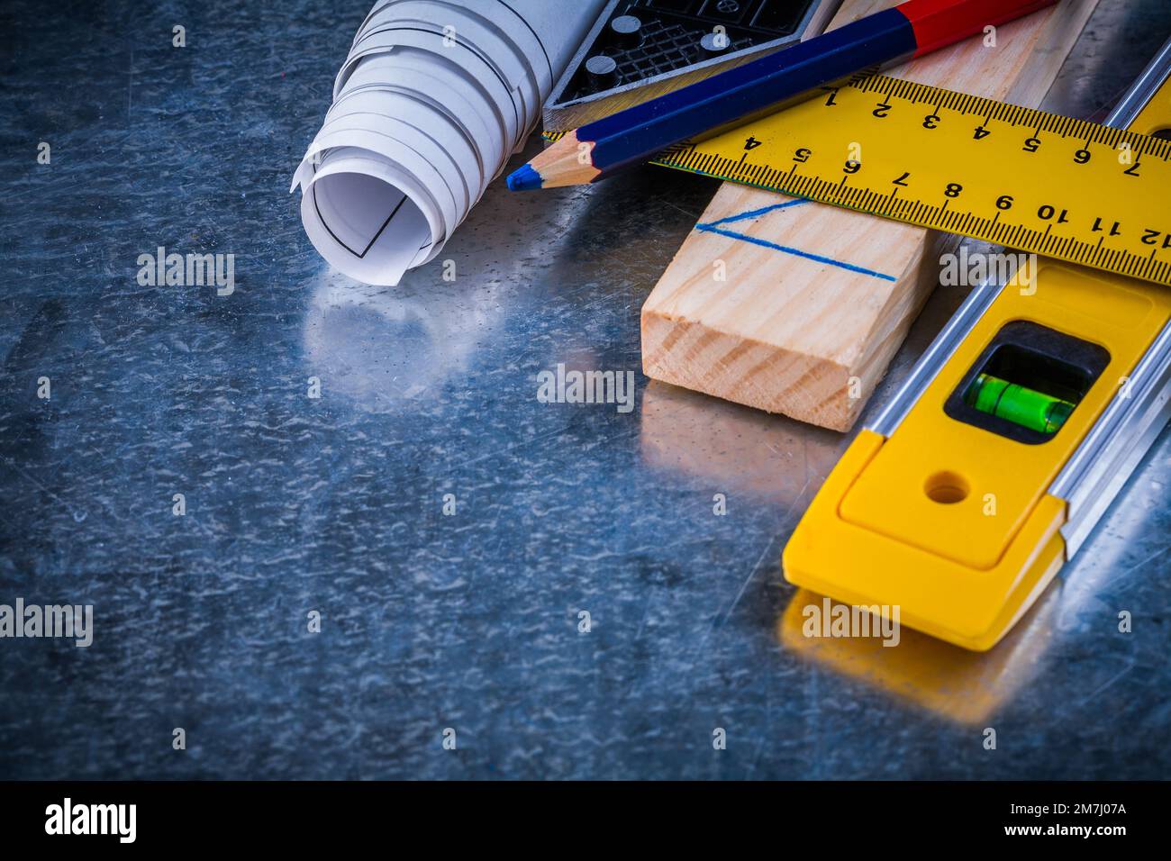 Pencil try square blueprints wooden brick and construction level on ...