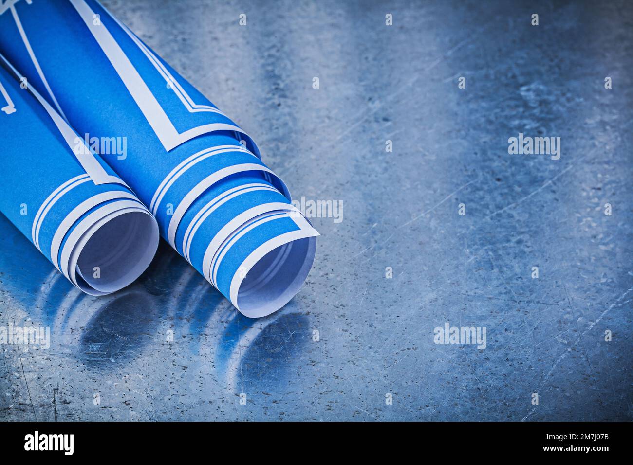 Pile of blue engineering drawings on metallic background construction ...