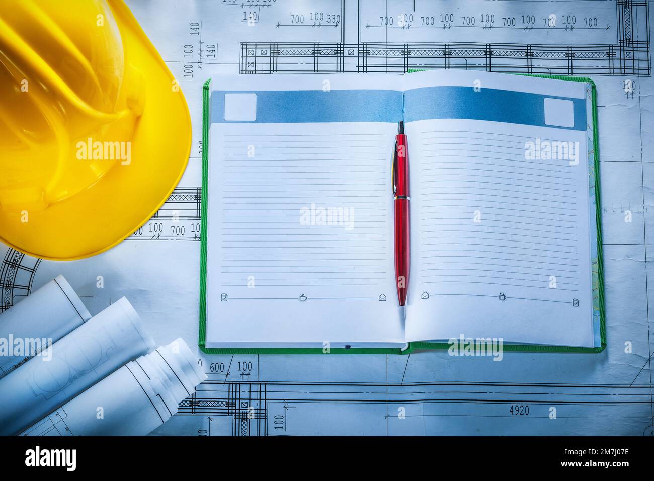 Pen hard hat construction plans notepad on blueprint Stock Photo - Alamy