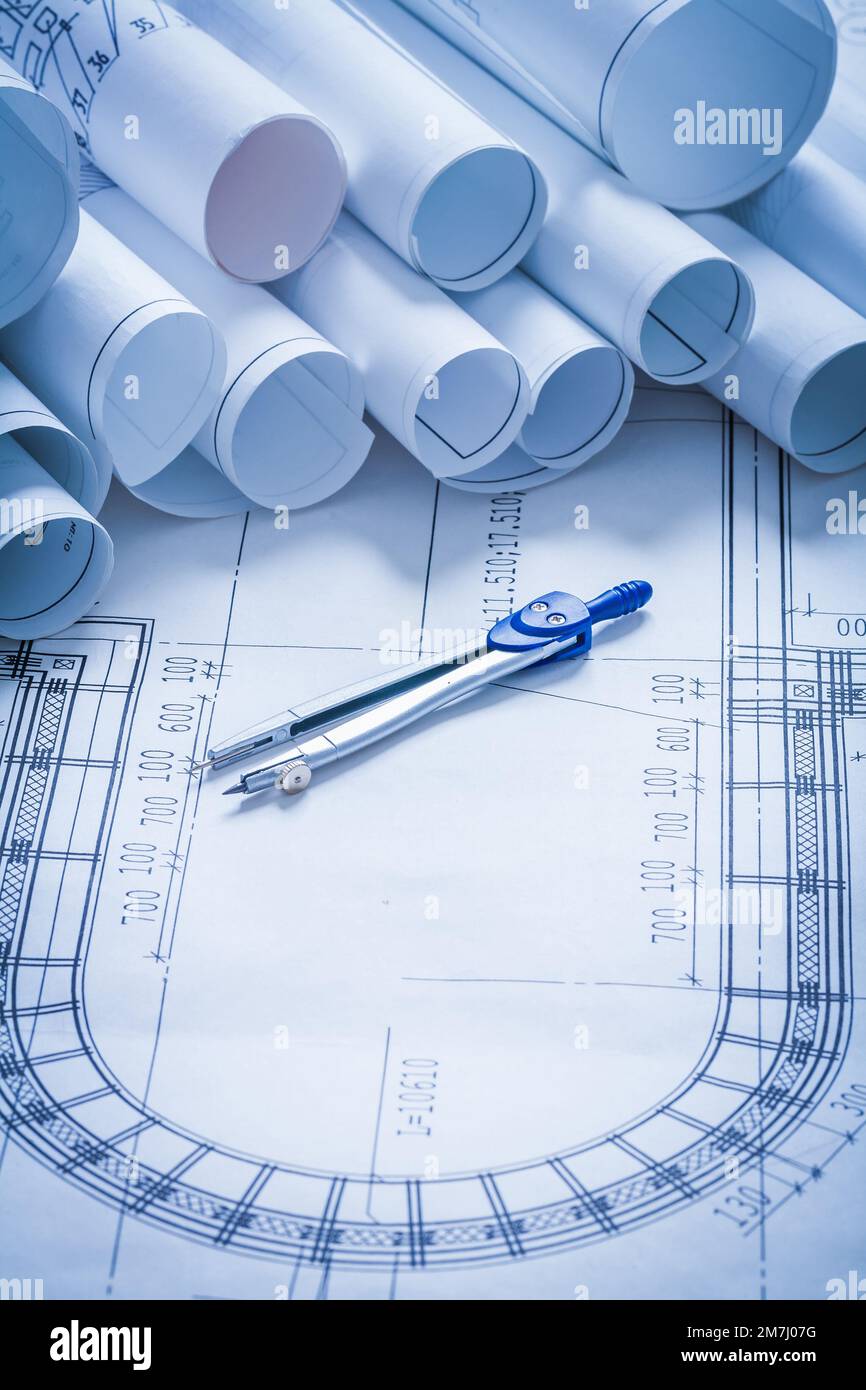 Pair of compasses with blueprints building and architecture concept ...