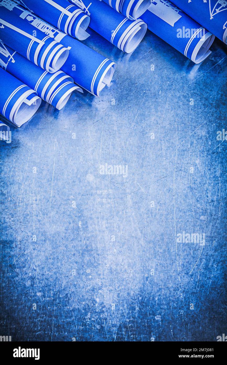 Pile of blue engineering drawings on metallic background construction ...