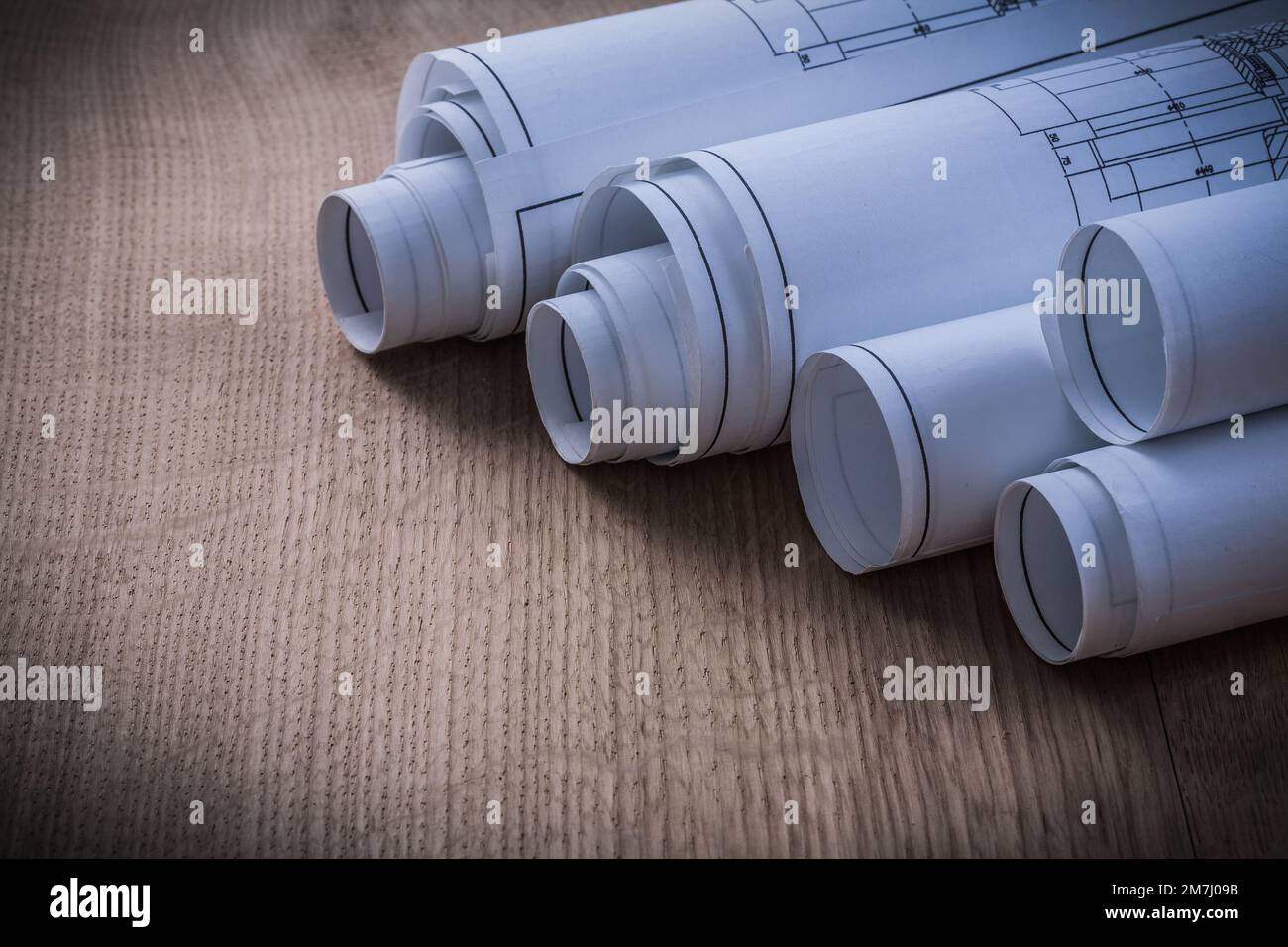 Pile of blueprint rolls on wooden board construction concept Stock ...