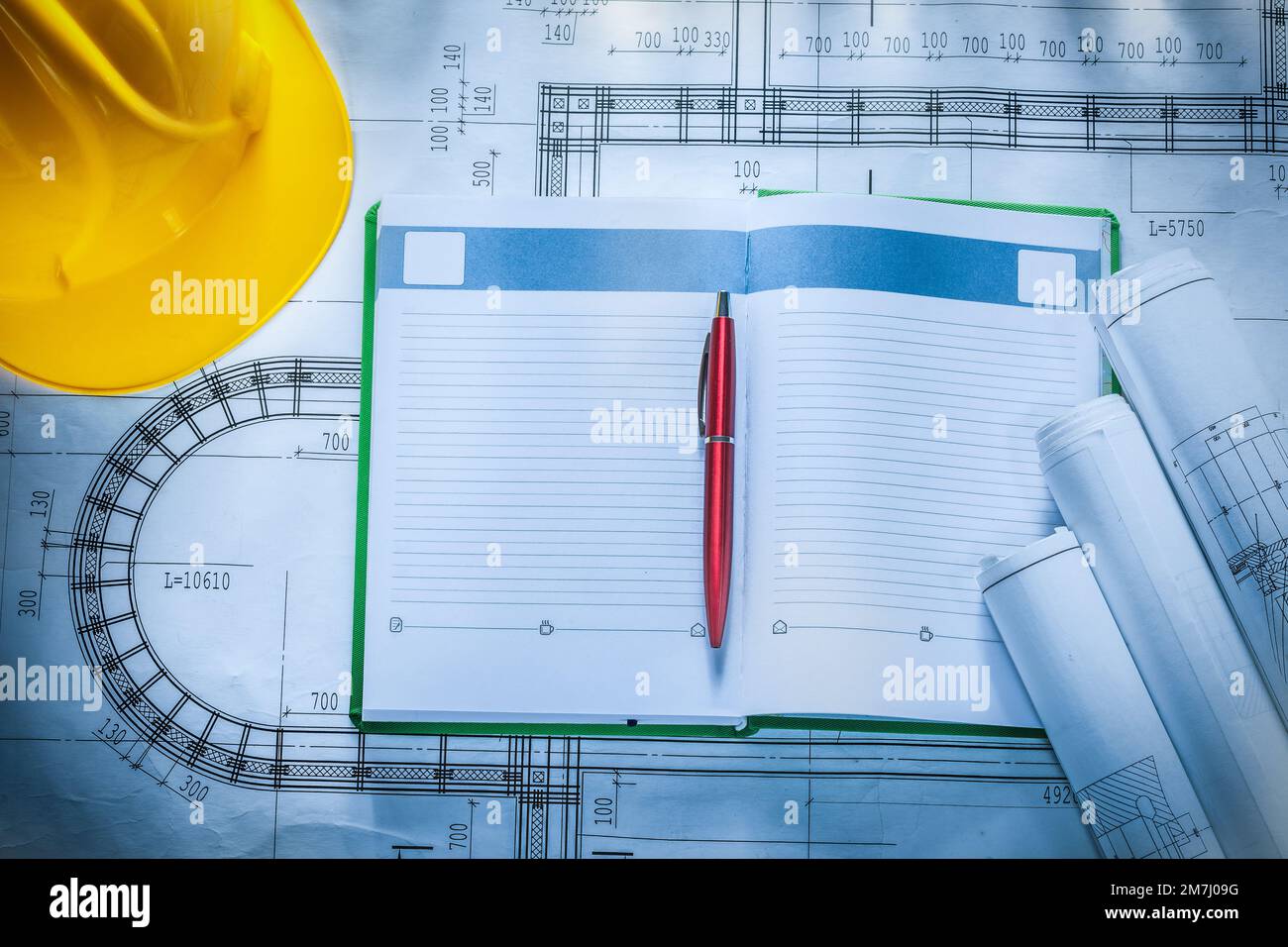 Pen hard hat construction drawings notepad on blueprint Stock Photo - Alamy