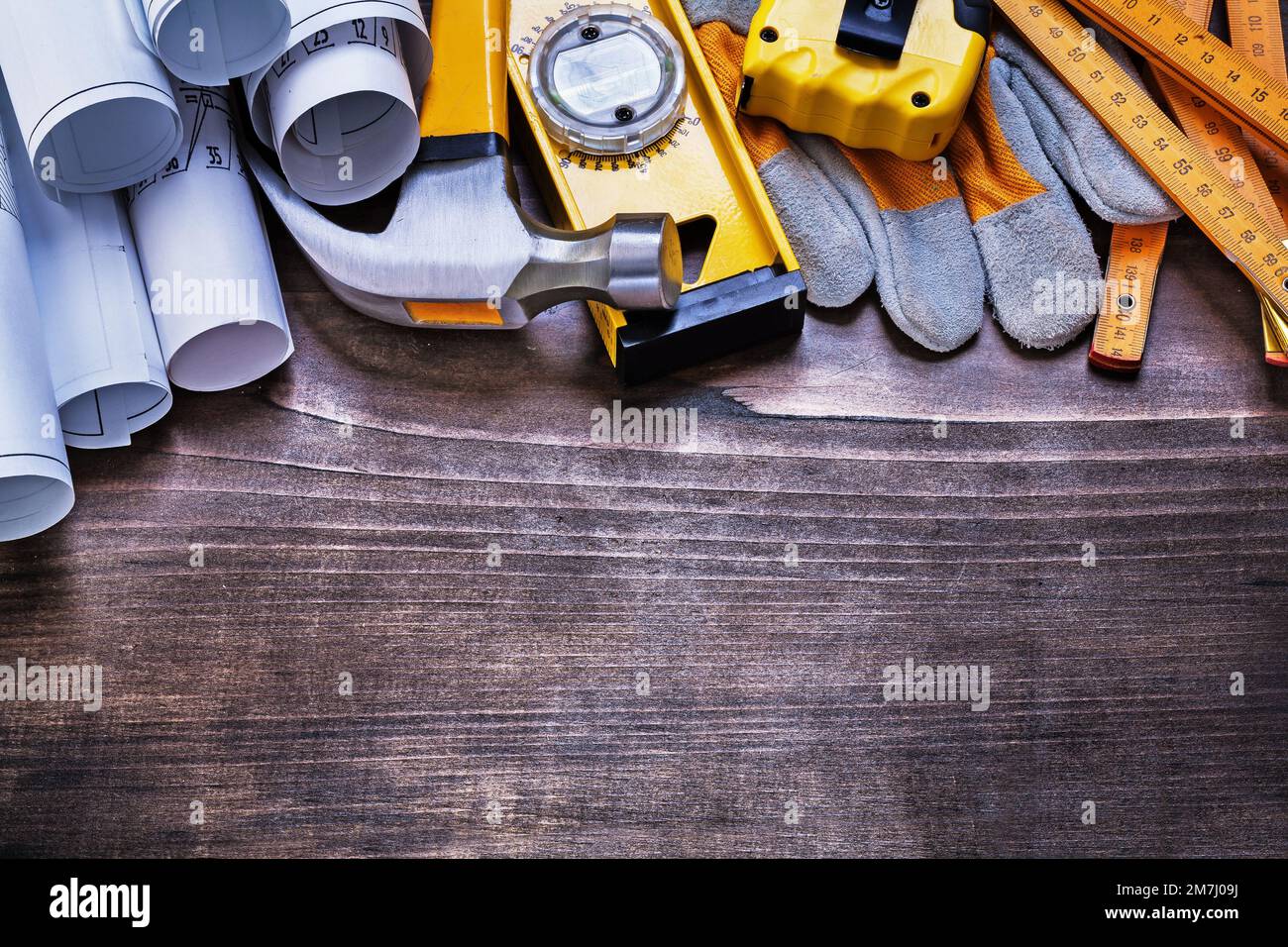 Pine wooden board with construction drawings and set of building ...
