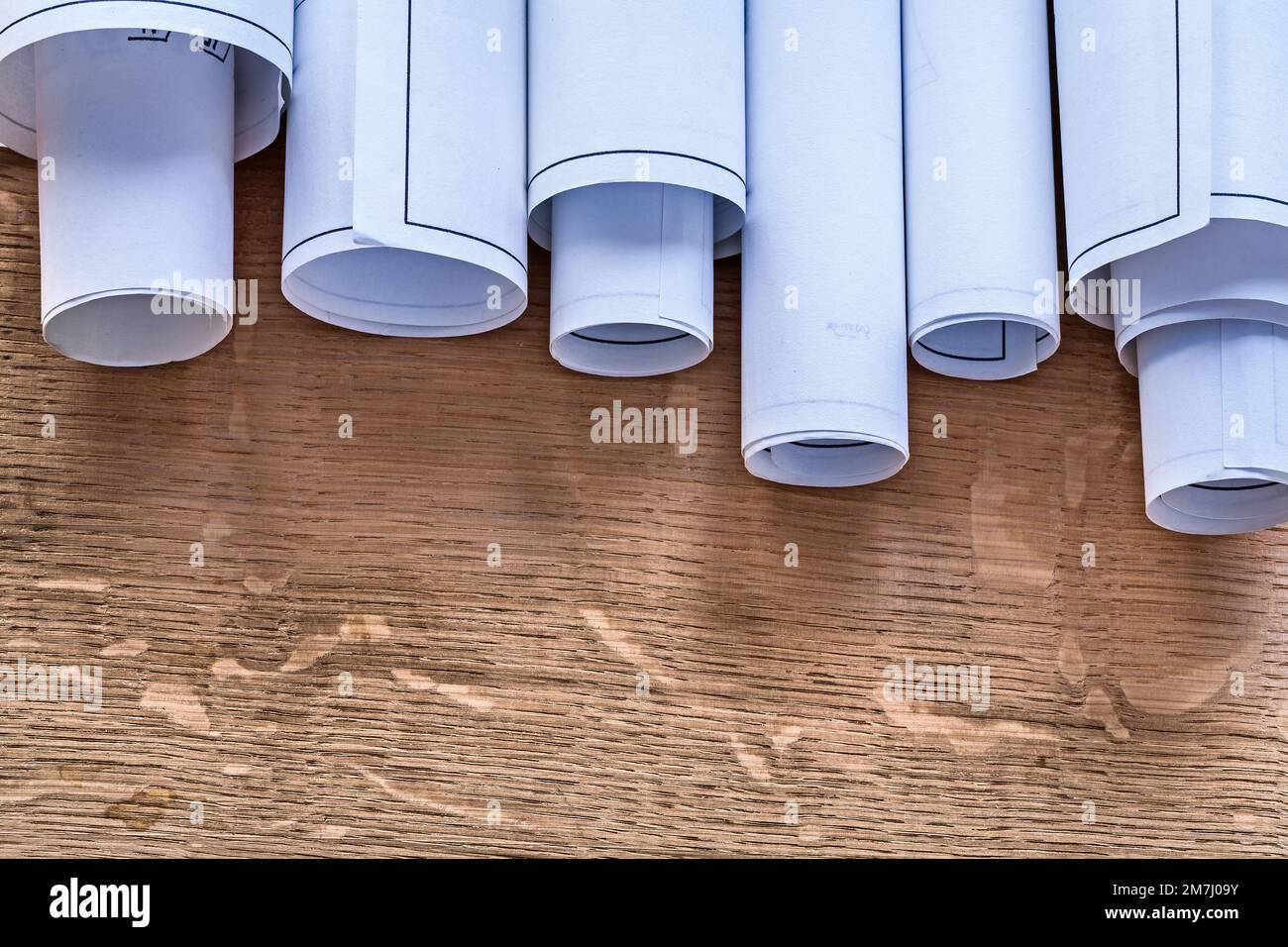 Pile of construction plans on wooden oaken board maintenance concept ...