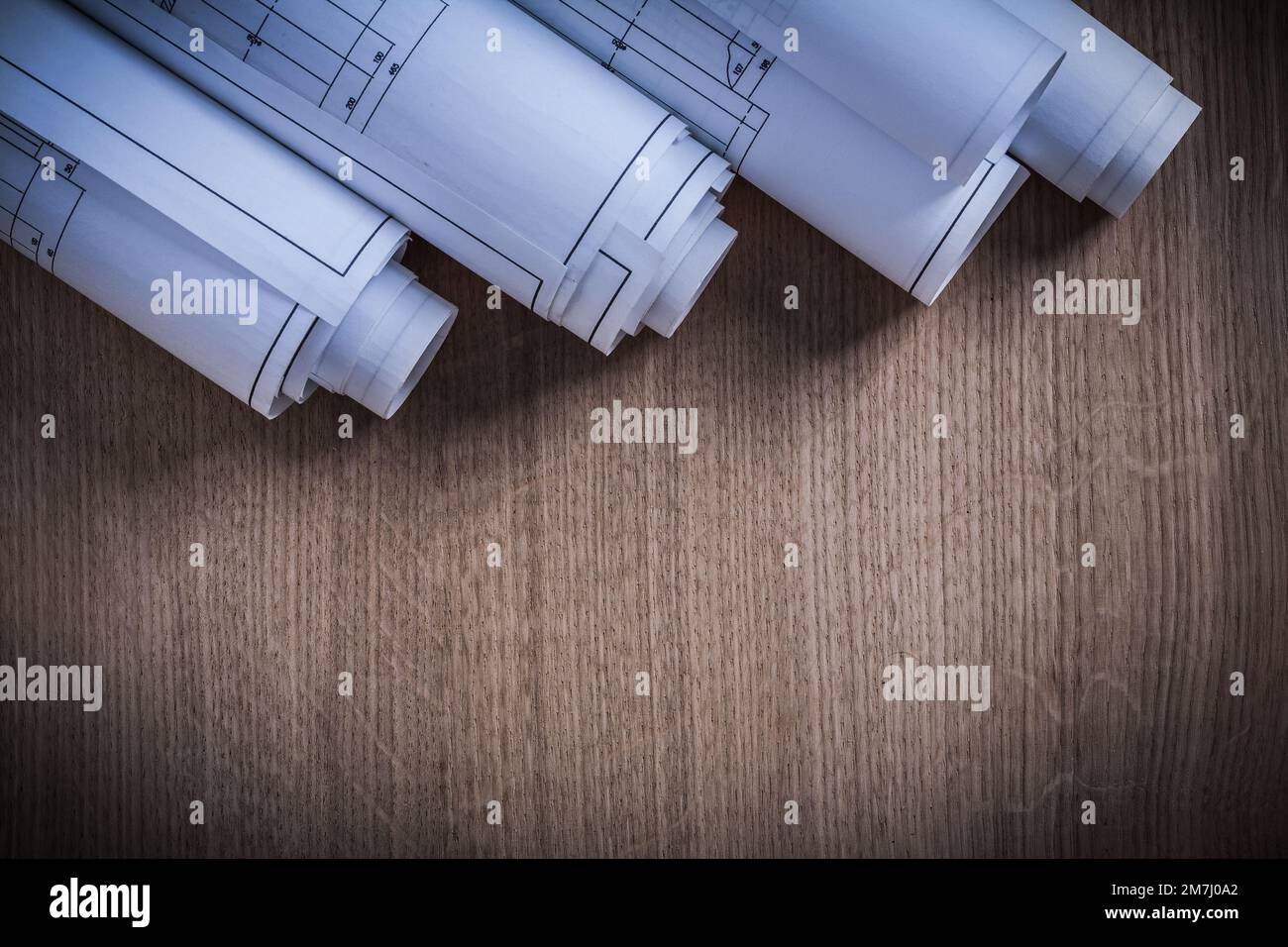 Pile of rolled construction plans architecture and building concept ...