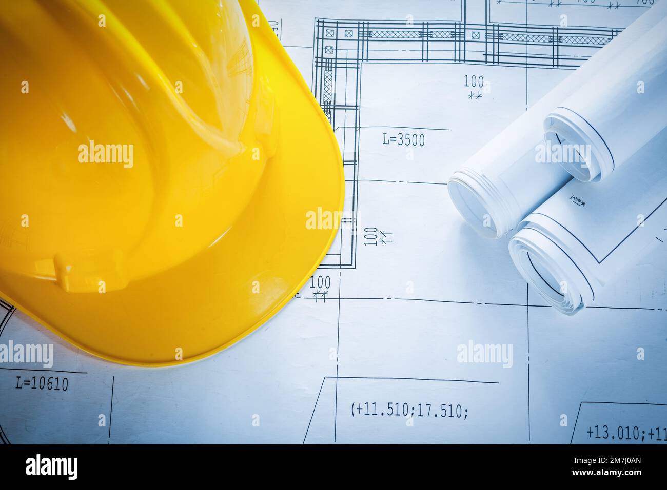 Protective building helmet construction plans on blueprint Stock Photo ...