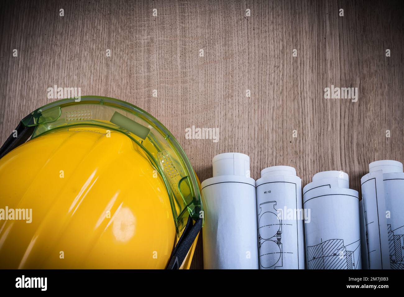 Plastic goggles rolled blueprints and building helmet construction ...