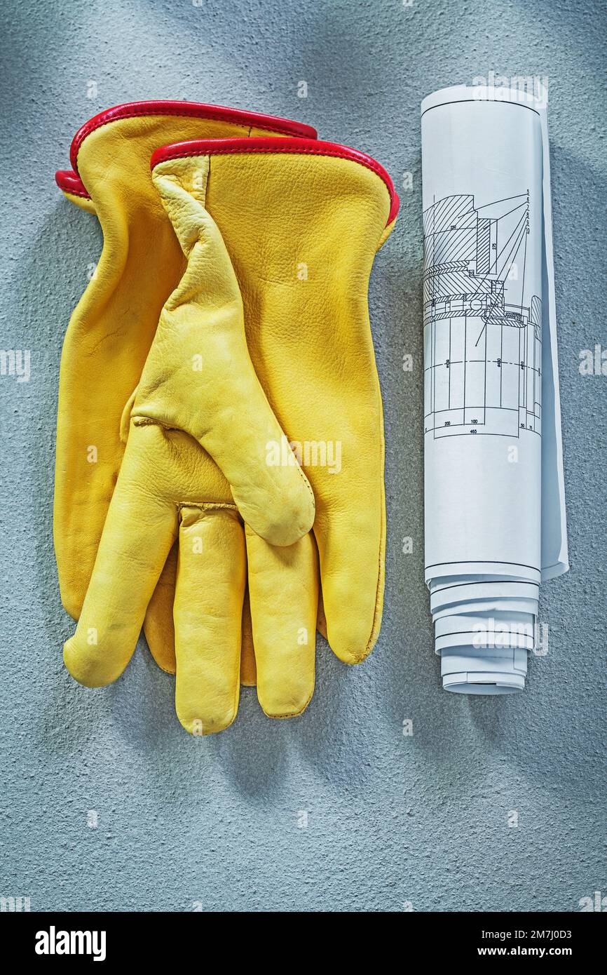 Protective gloves engineering drawings on concrete surface construction ...