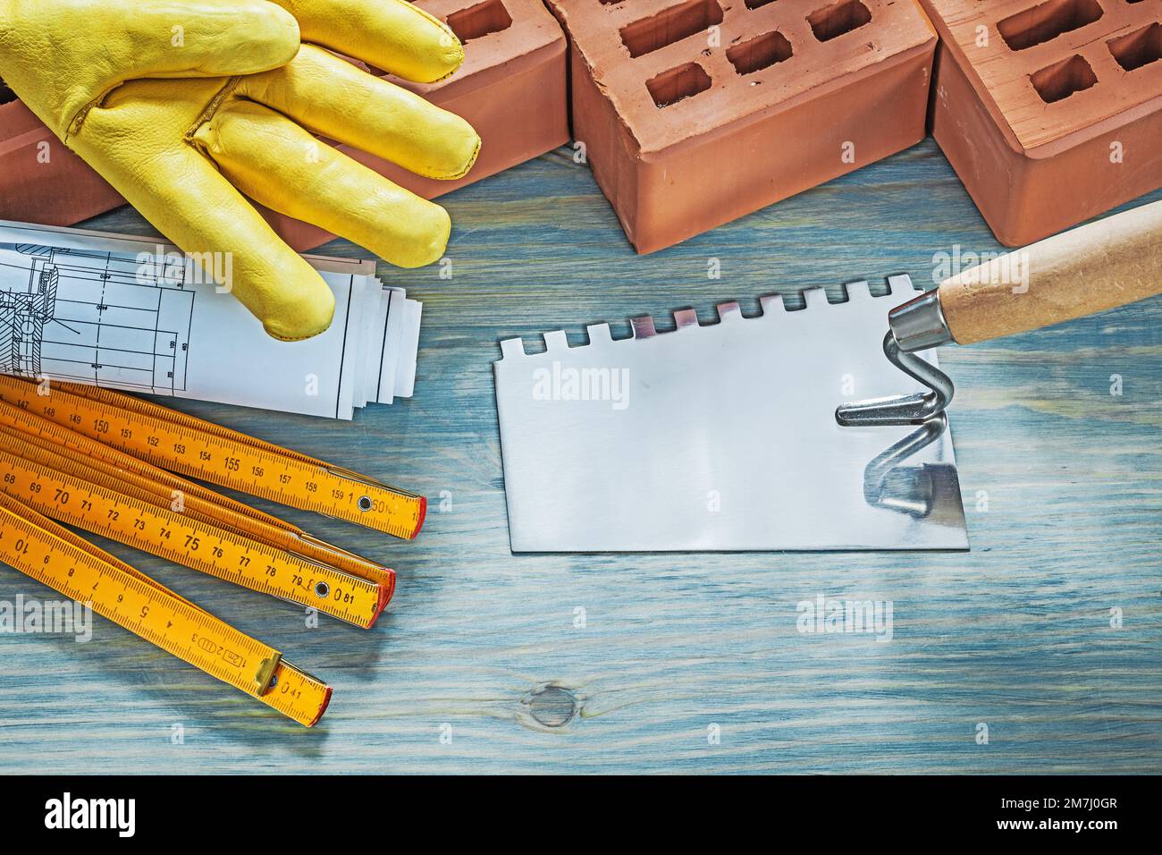 Red bricks working gloves construction drawings wooden meter palette ...
