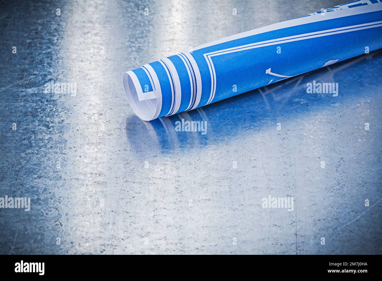 Roll of engineering drawings on metallic background construction ...