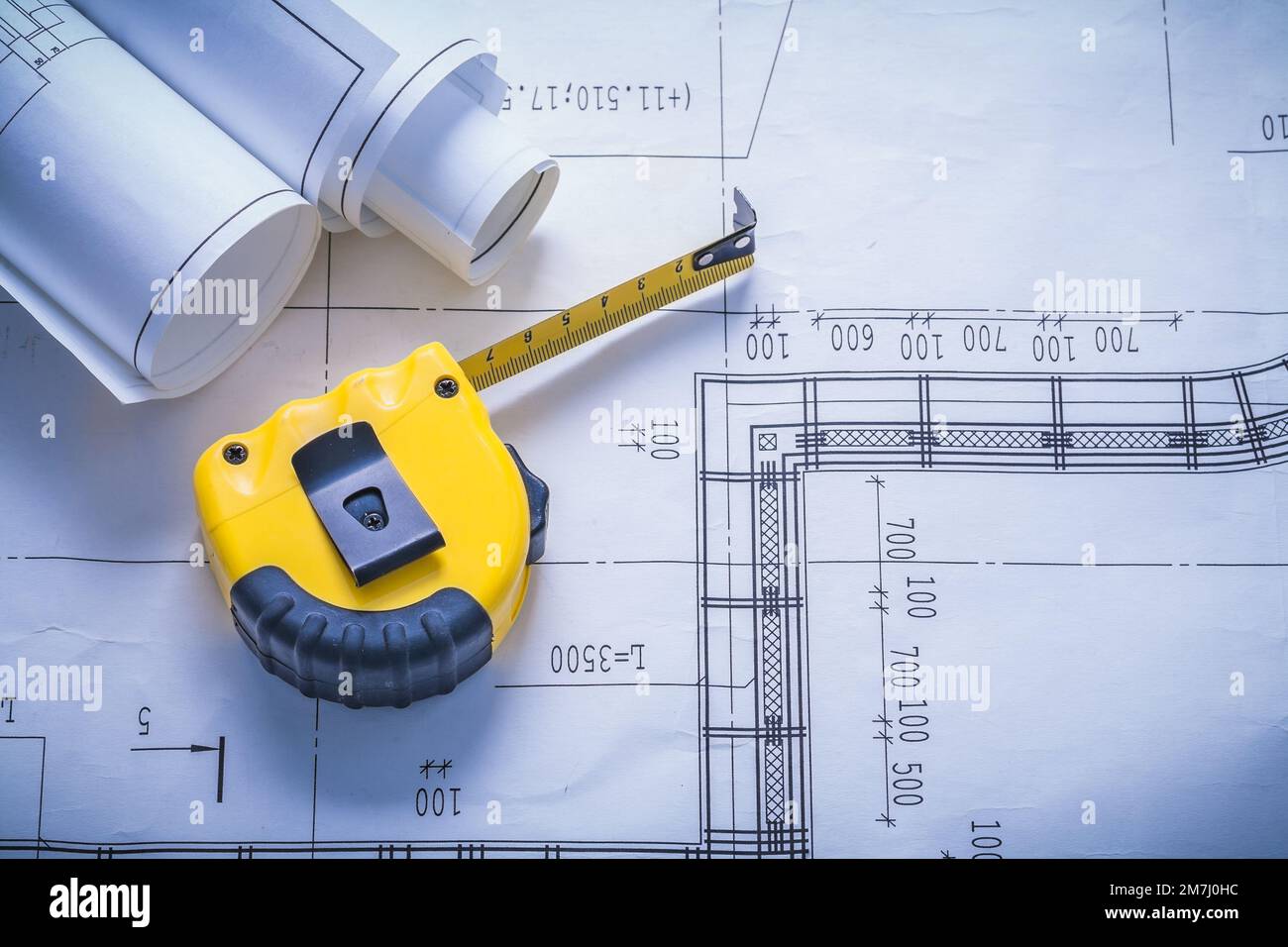 rolled blueprints and measure tape Stock Photo - Alamy
