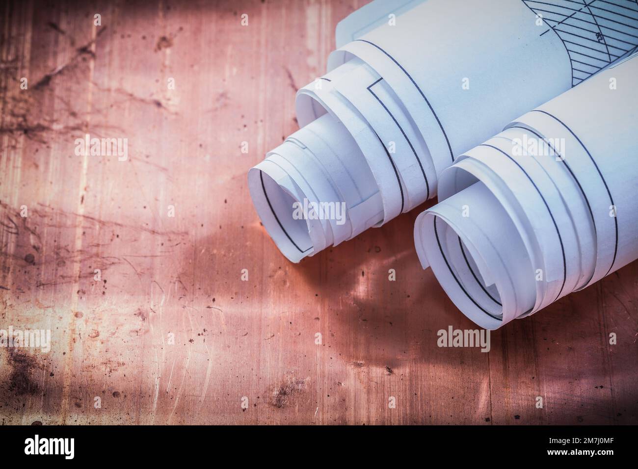 Rolled blueprints on brazen background construction concept Stock Photo ...