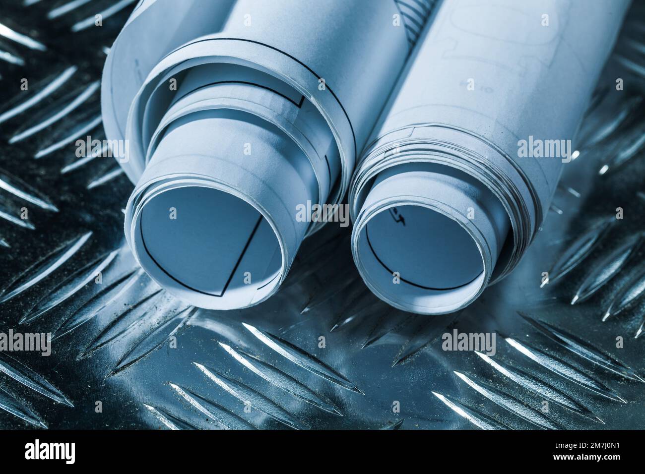 Rolled construction drawings on channeled metal sheet Stock Photo - Alamy