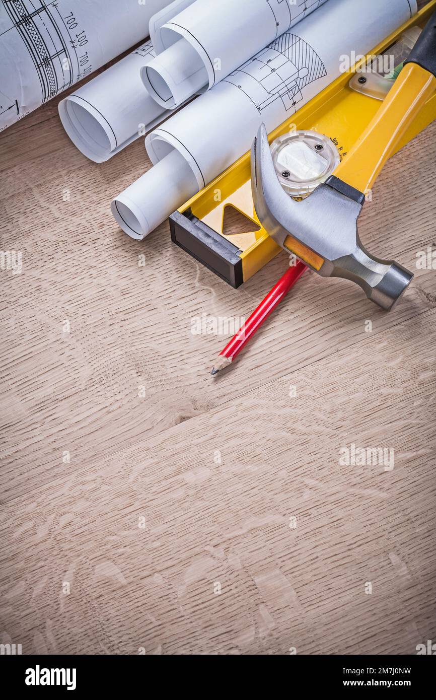 rolled blueprints hammer level pencil on wood board Stock Photo - Alamy