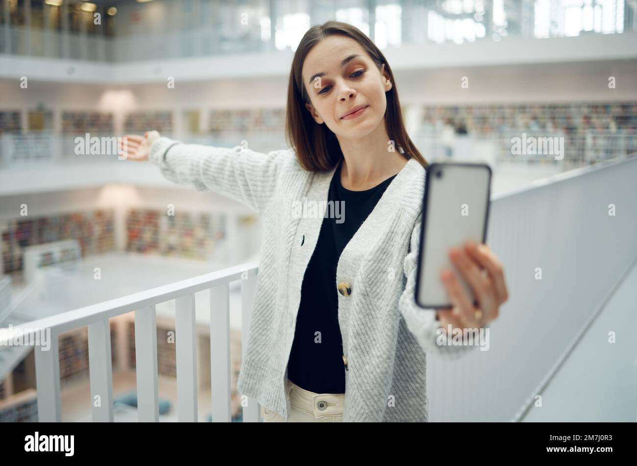 Selfie, library and student with smartphone for social media, video ...