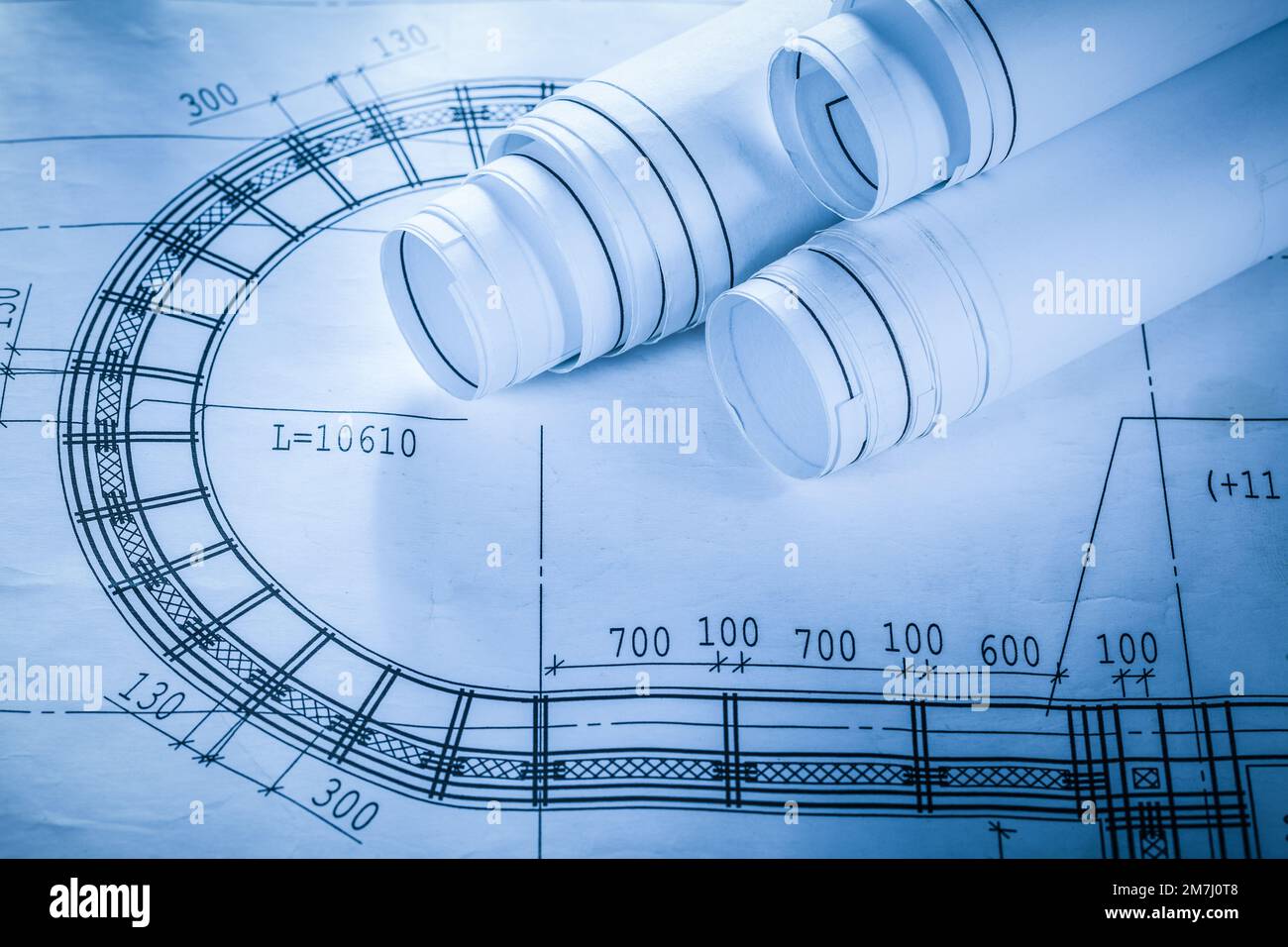 Rolled construction drawings on blueprint Stock Photo - Alamy