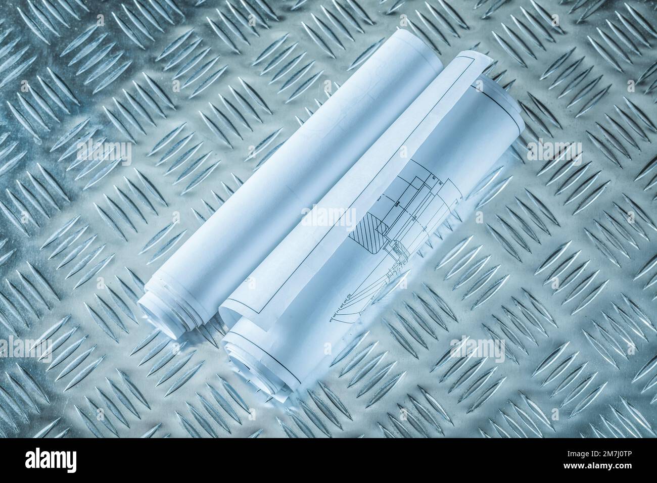 Rolled construction plans on corrugated metal background Stock Photo ...