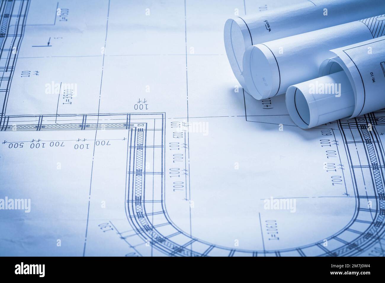 Rolled up blueprint rolls construction concept Stock Photo - Alamy