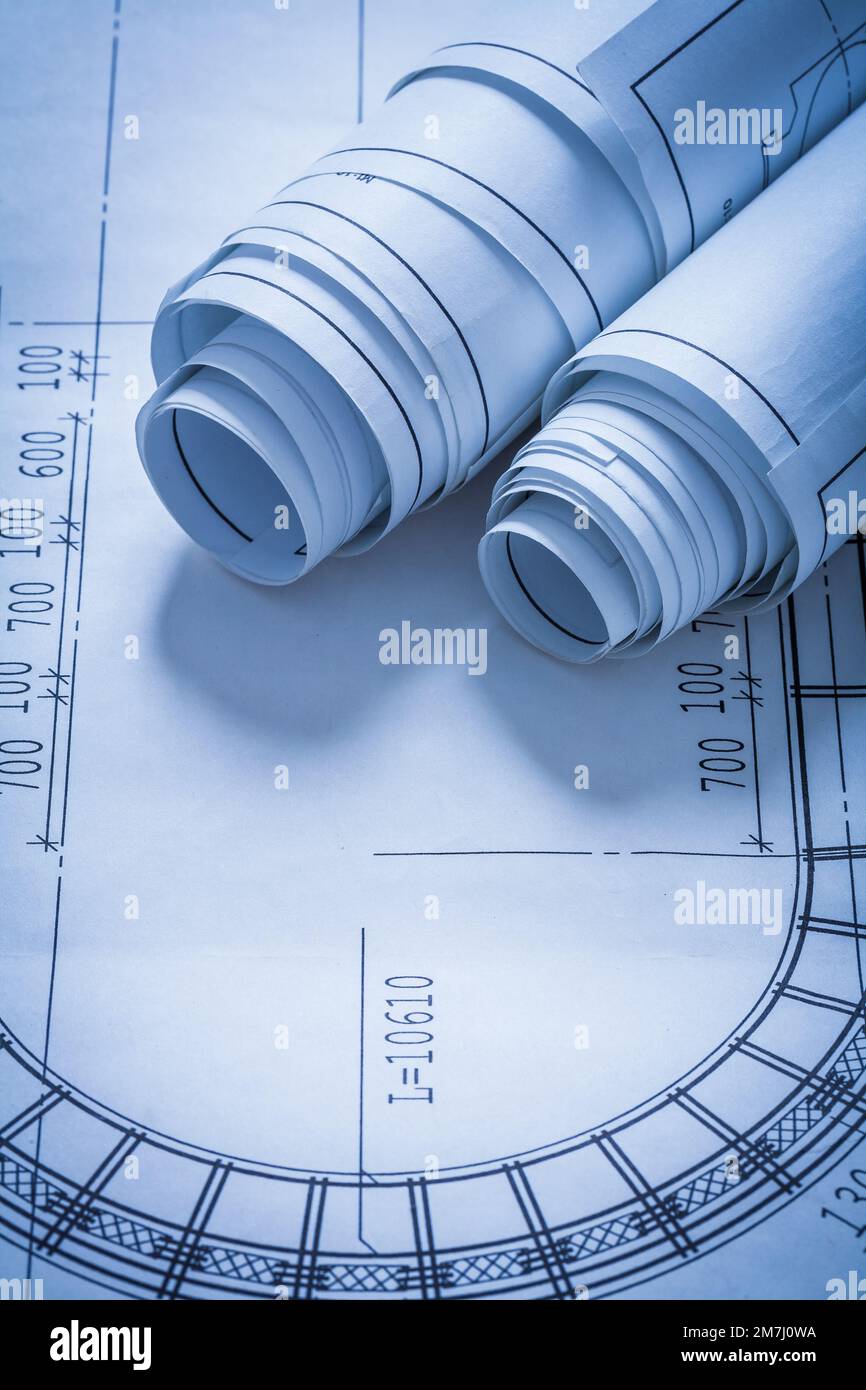 Rolled up construction drawings building concept Stock Photo - Alamy