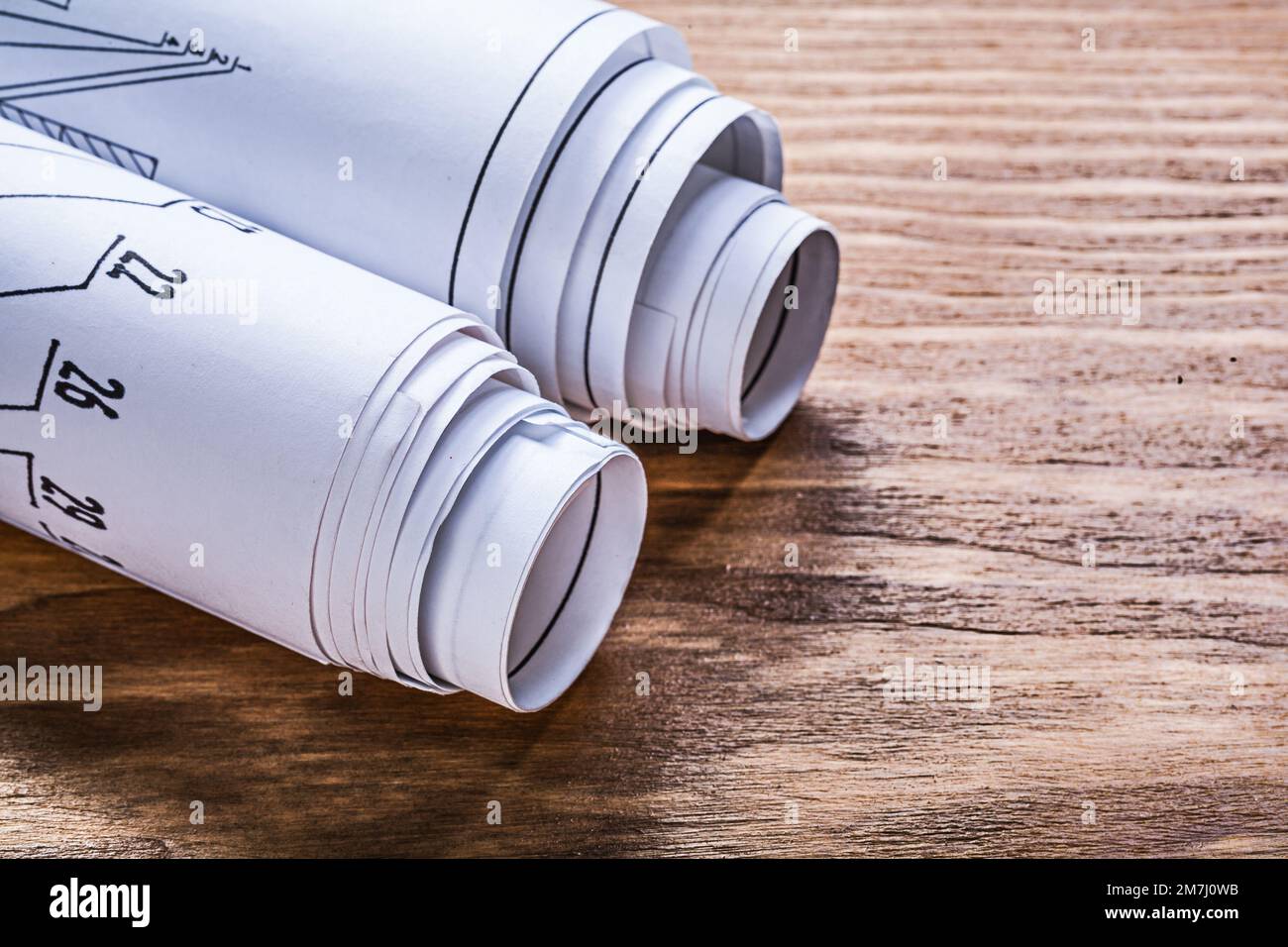 Rolled engineering drawings on wooden board construction concept Stock ...