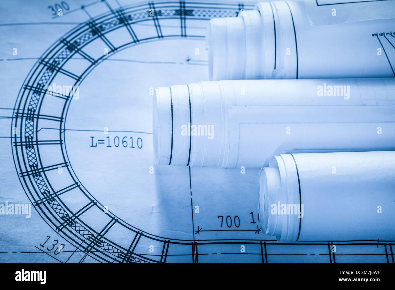 Rolled engineering drawings on blueprint Stock Photo - Alamy