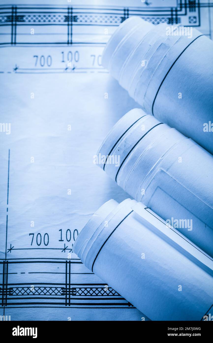 Rolled up construction drawings on blueprint top view Stock Photo - Alamy