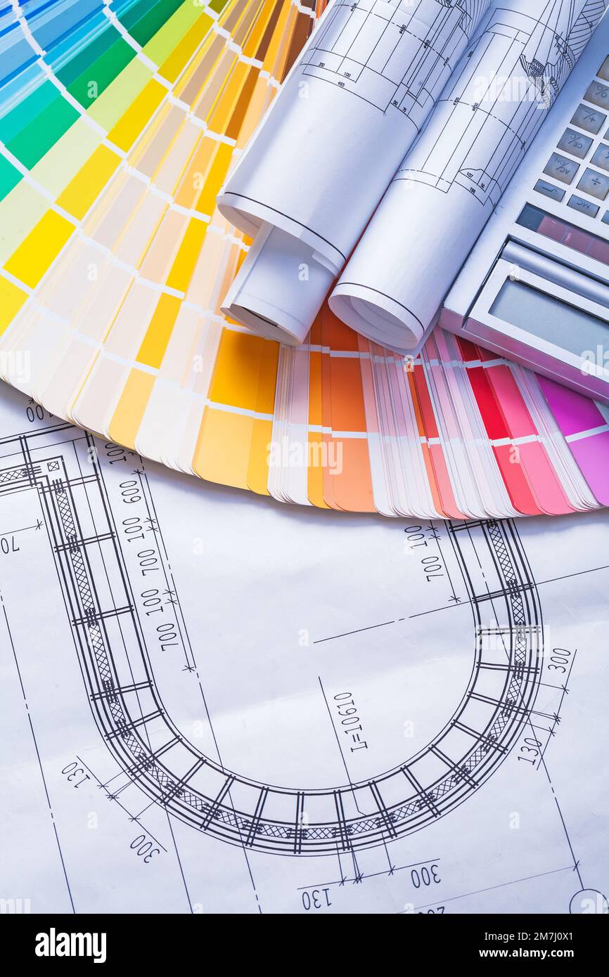 rolled up blueprints on color palette and calculator Stock Photo - Alamy