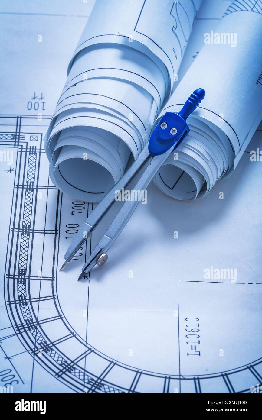 Rolls of blueprints and drawing compass construction concept Stock ...