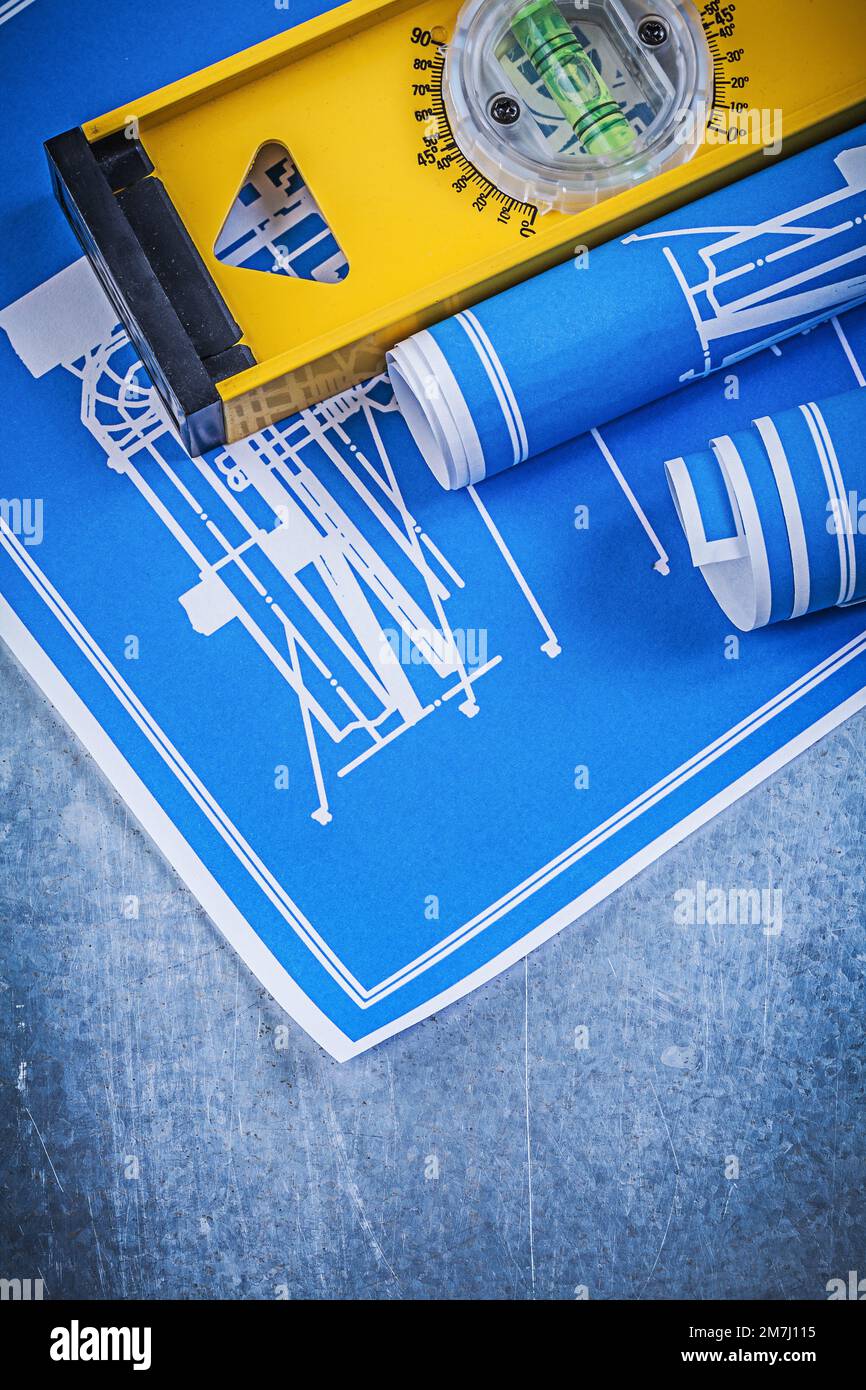 Rolls of blue engineering drawings level on metallic background Stock ...