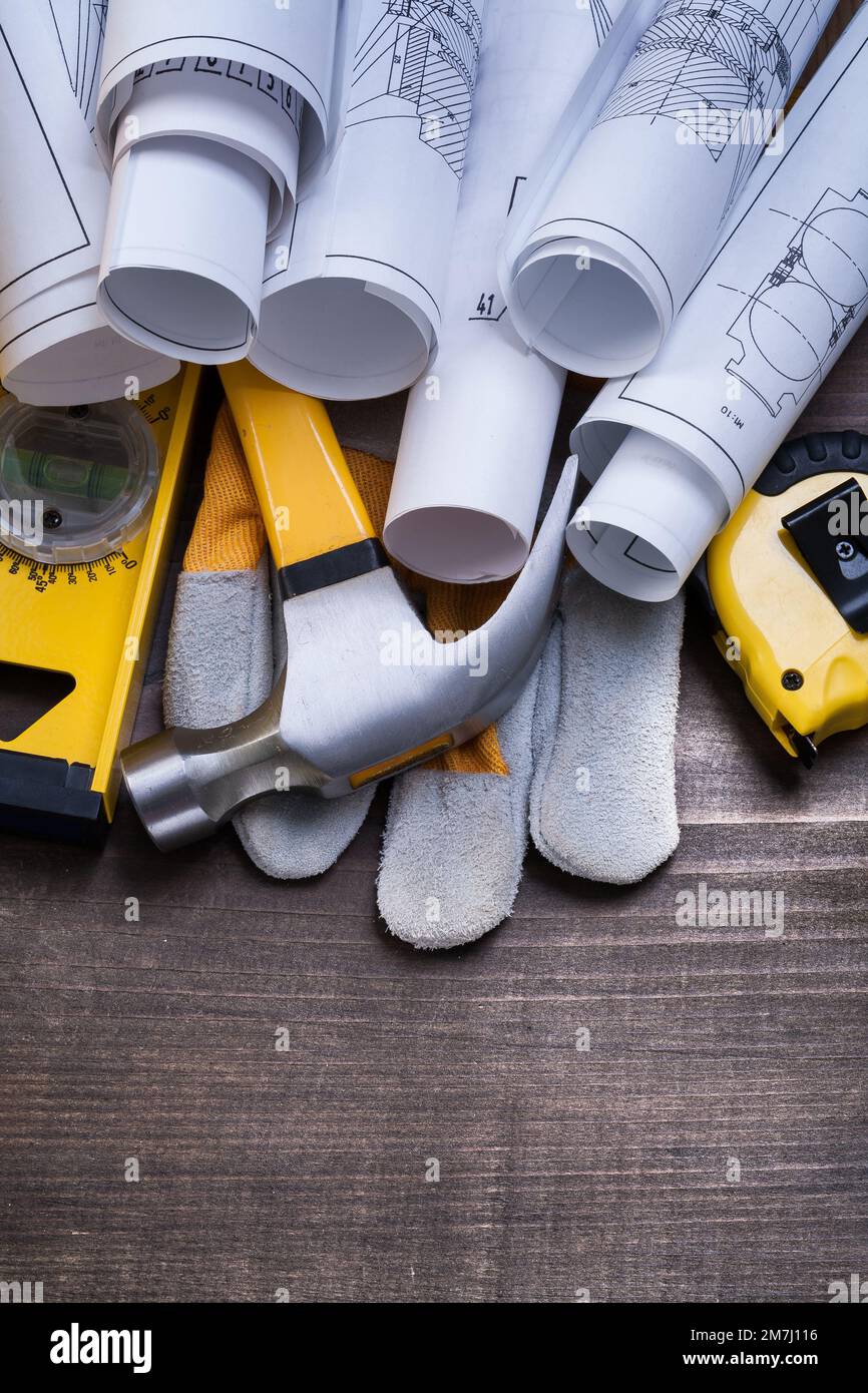Rolls of blueprints hammer protective glove construction level tape ...