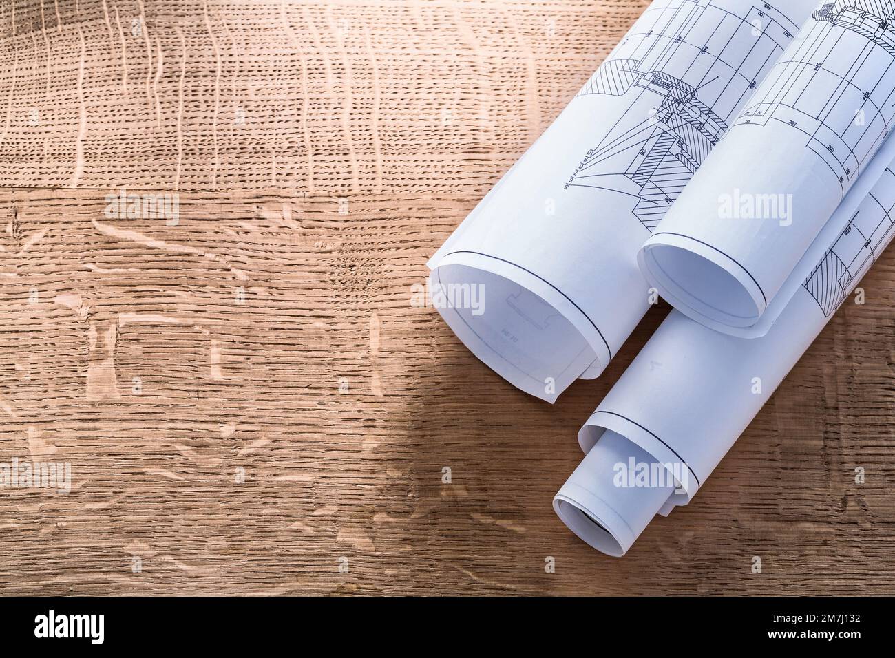 Rolls of blueprints on wooden oaken board construction concept Stock ...