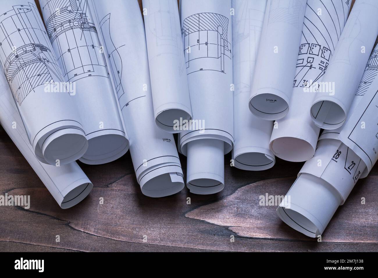 Rolls of construction plans on pine wooden vintage board maintenance ...