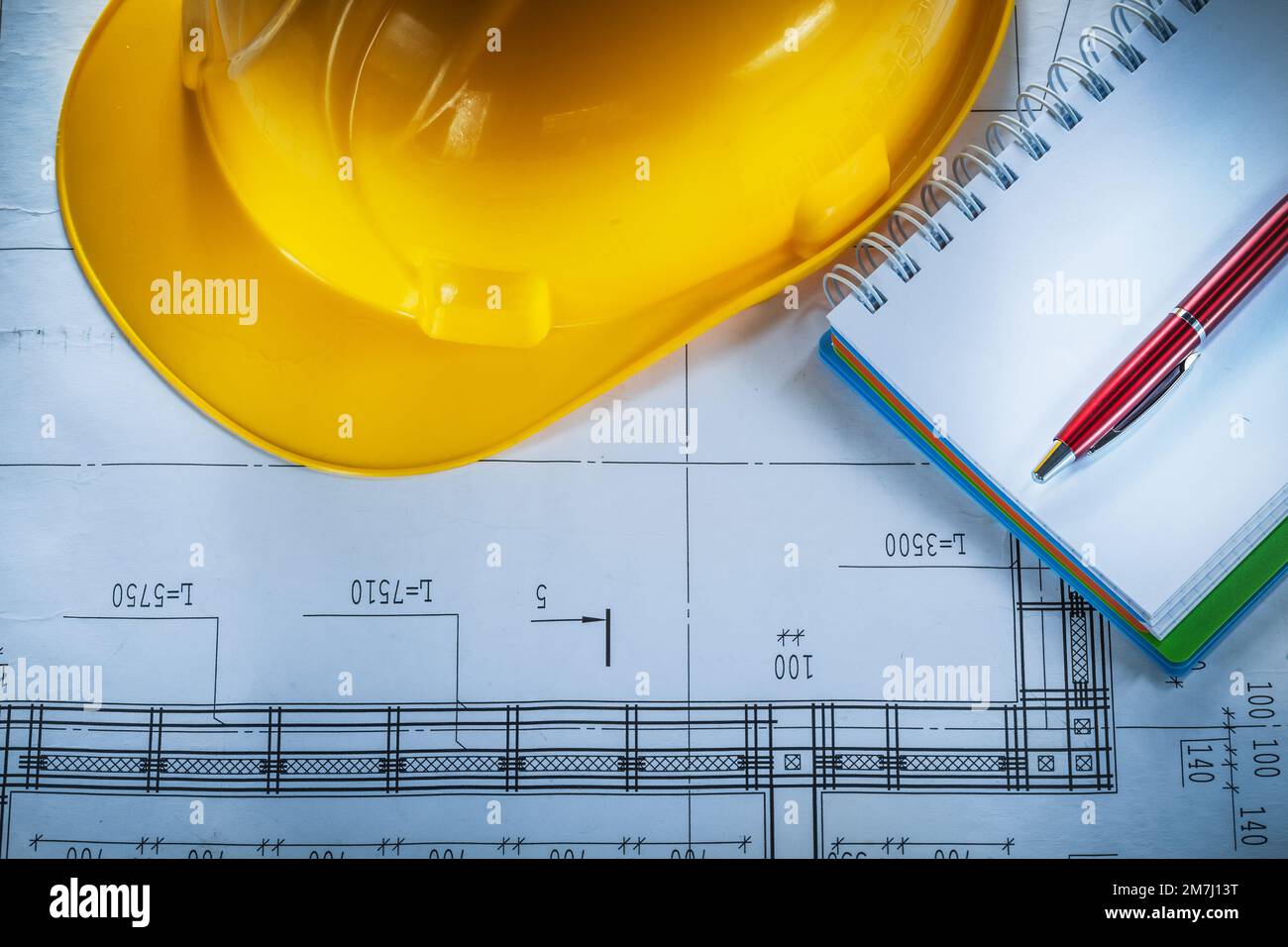 Safety building helmet notebook pen on blueprint Stock Photo - Alamy