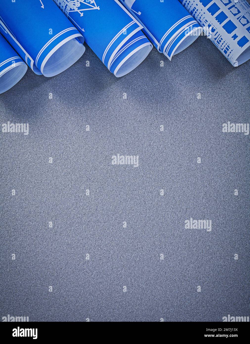 Rolls of engineering drawings on grey background copy space ...