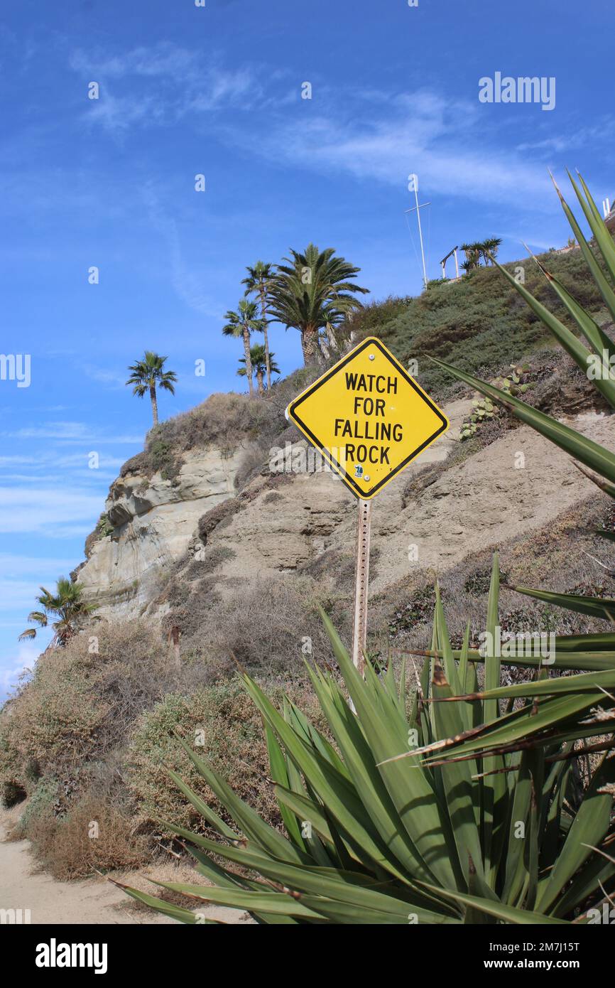 Cautionary sign near trail cliff Stock Photo - Alamy