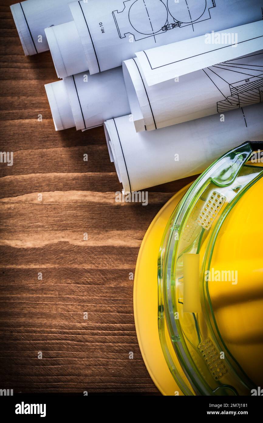 Safety goggles construction drawings and building helmet on wooden ...
