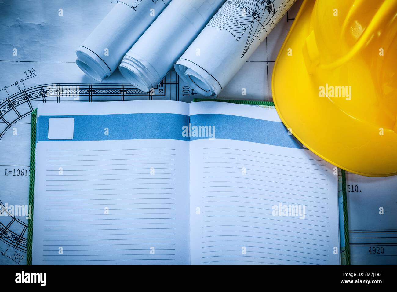 Safety hard hat construction plans notepad on blueprint Stock Photo - Alamy