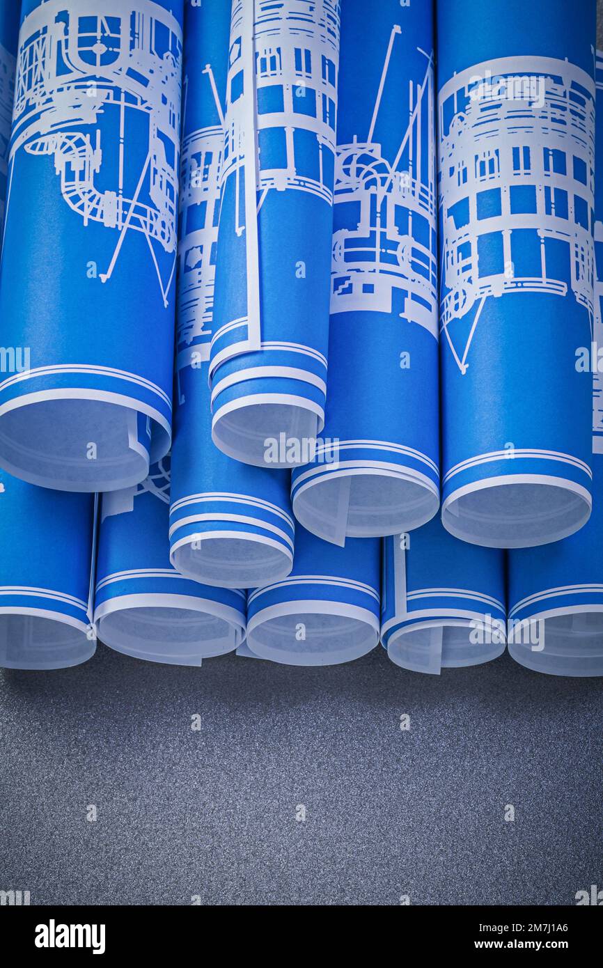 Set of blue rolled engineering drawings on grey background construction ...