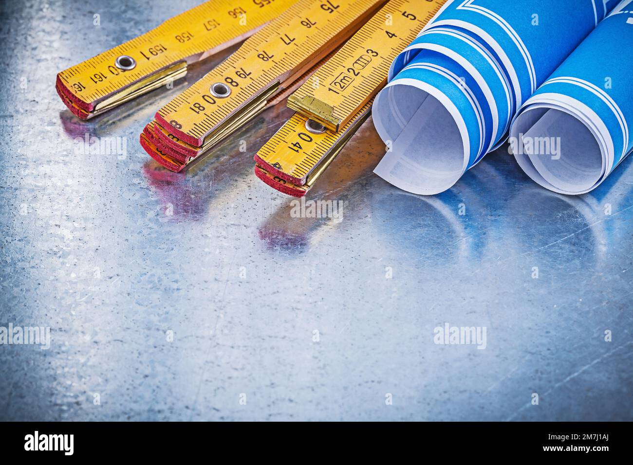 Set of blue construction drawings wooden meter on metallic background ...