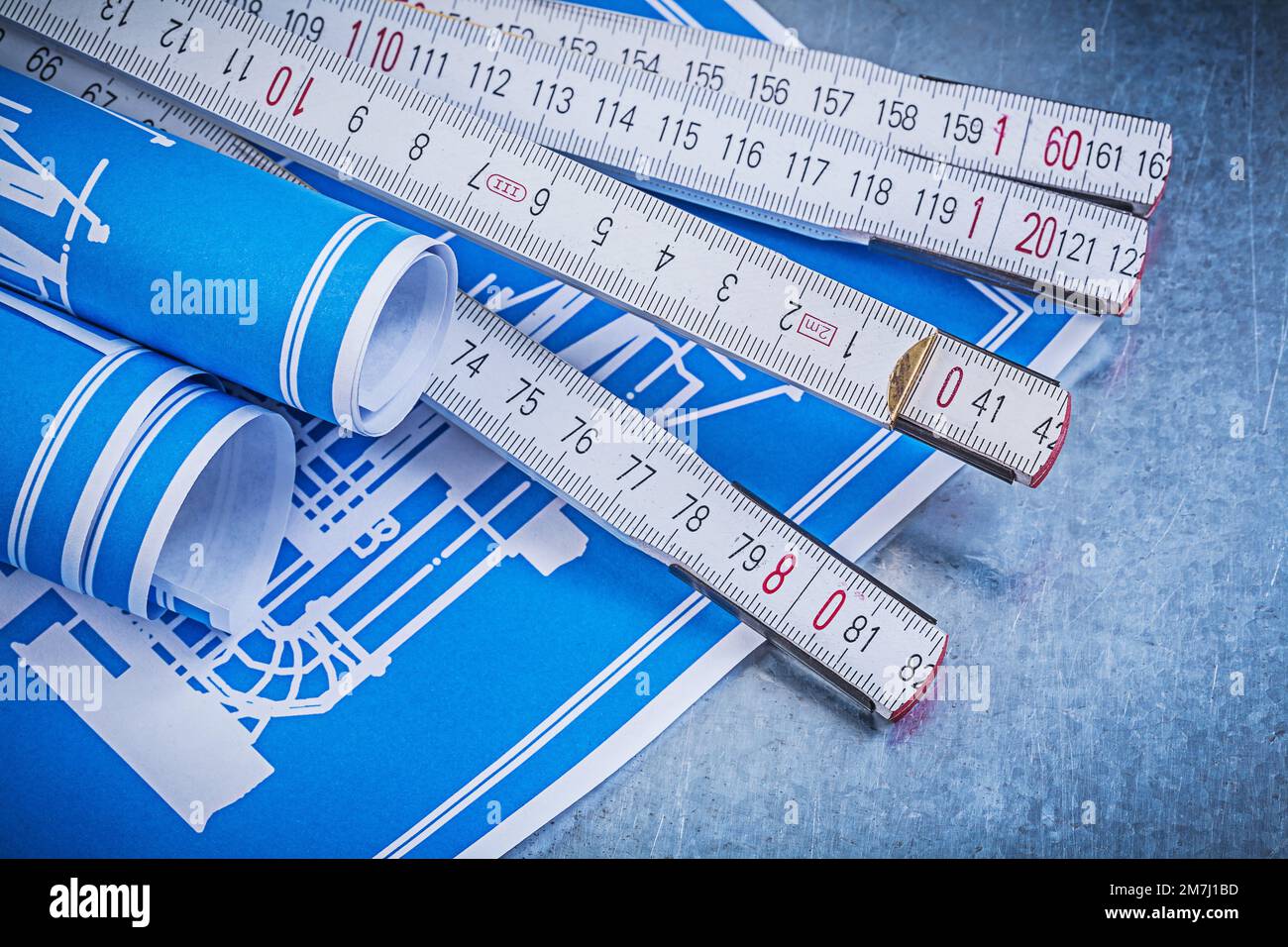 Set of blue engineering drawings wooden meter on metallic background ...