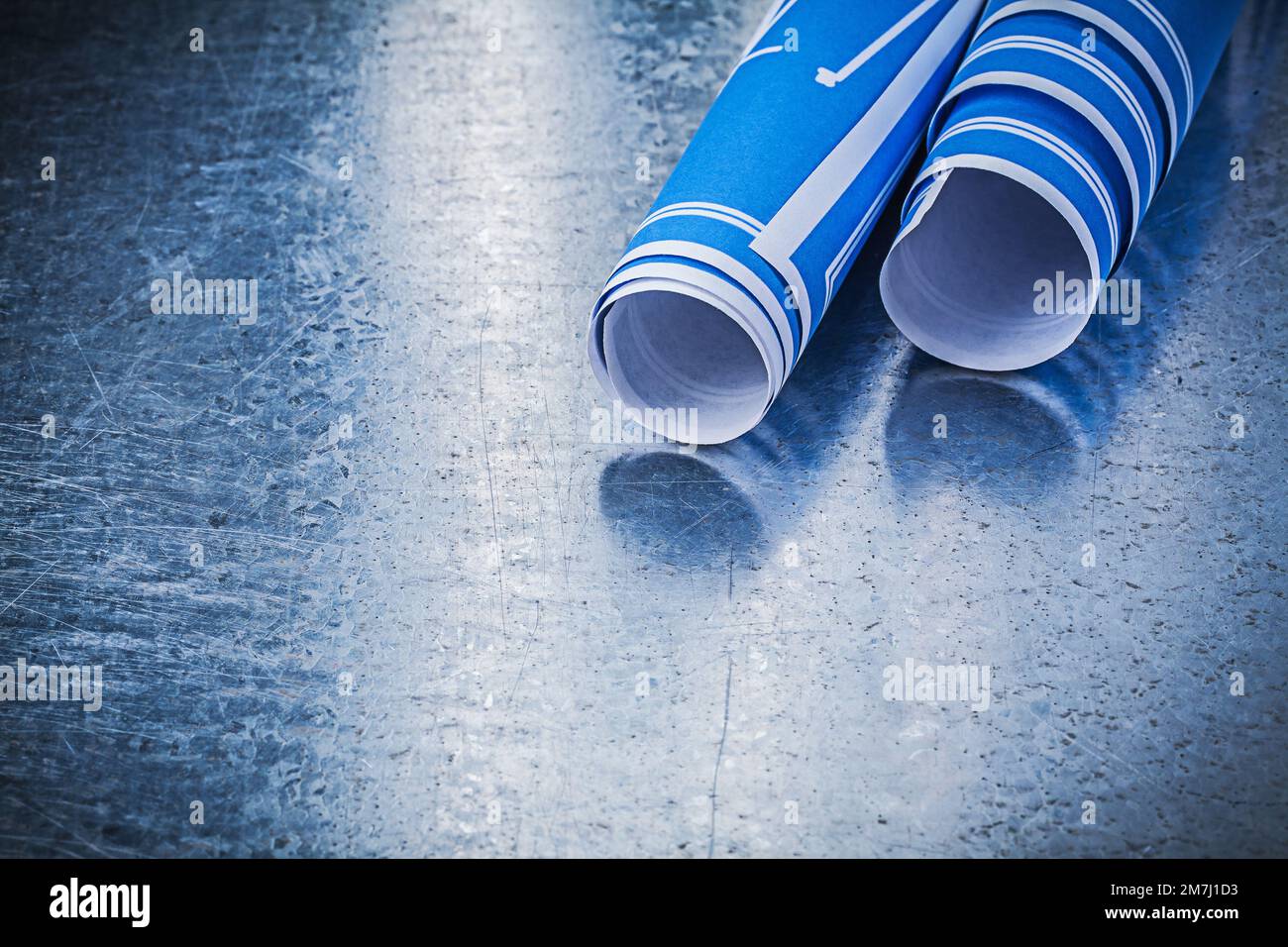 Stack of blue construction plans on metallic background building ...