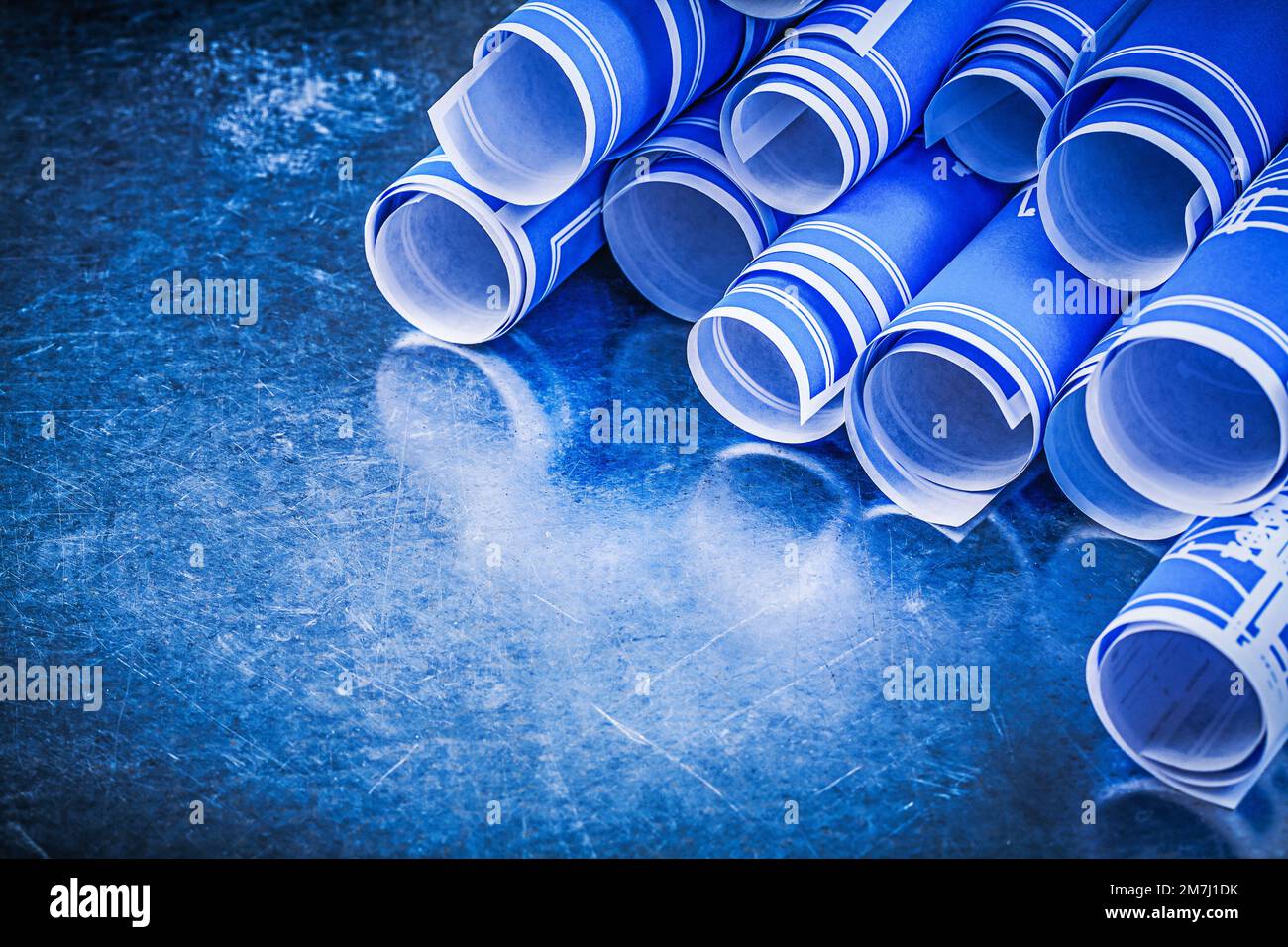Stack of blue engineering drawings on metallic background construction ...