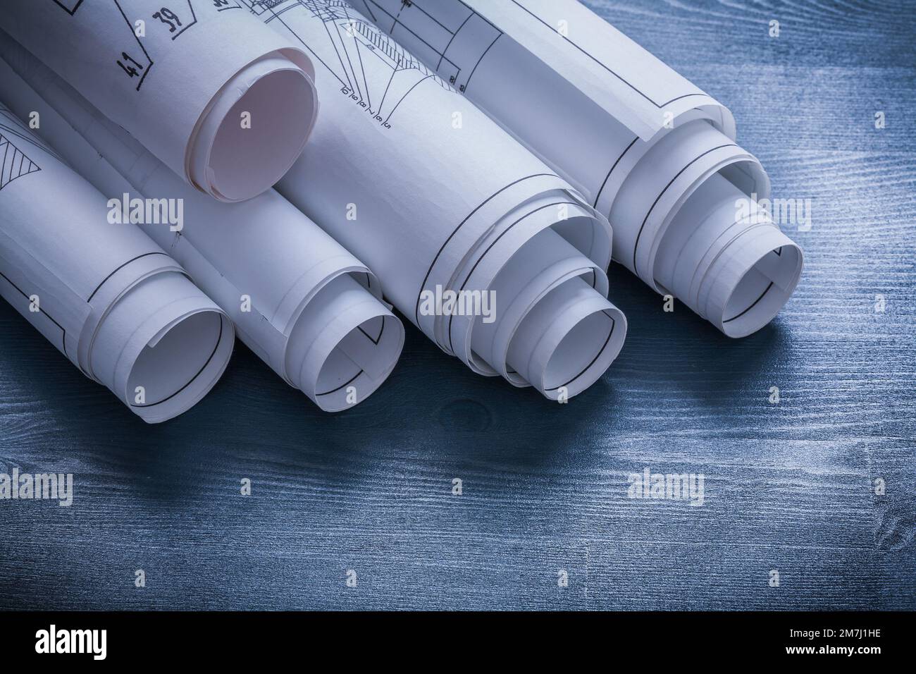 stack of rolled blueprints on board Stock Photo - Alamy