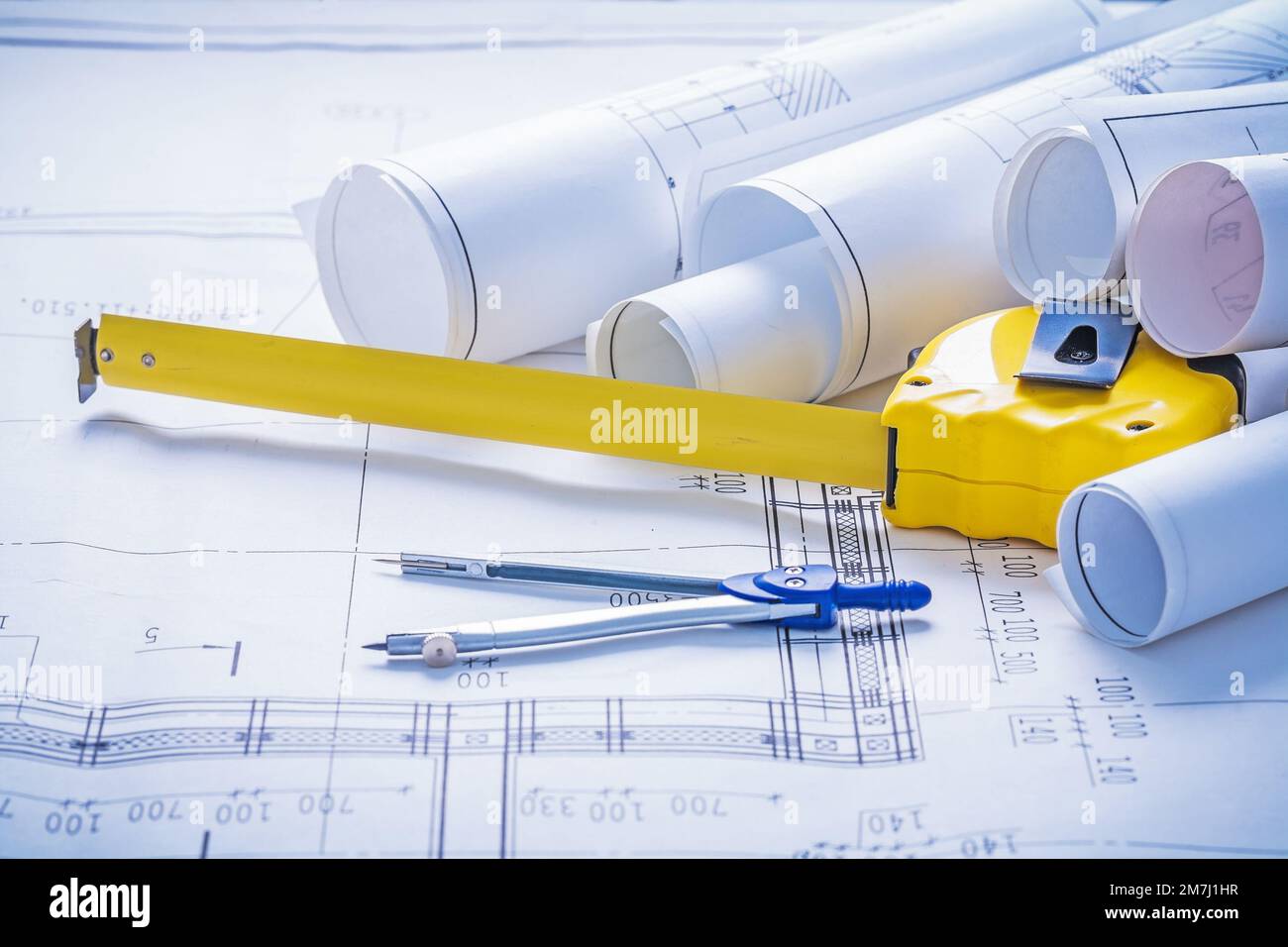 tapeline compass rolls of blueprints Stock Photo - Alamy