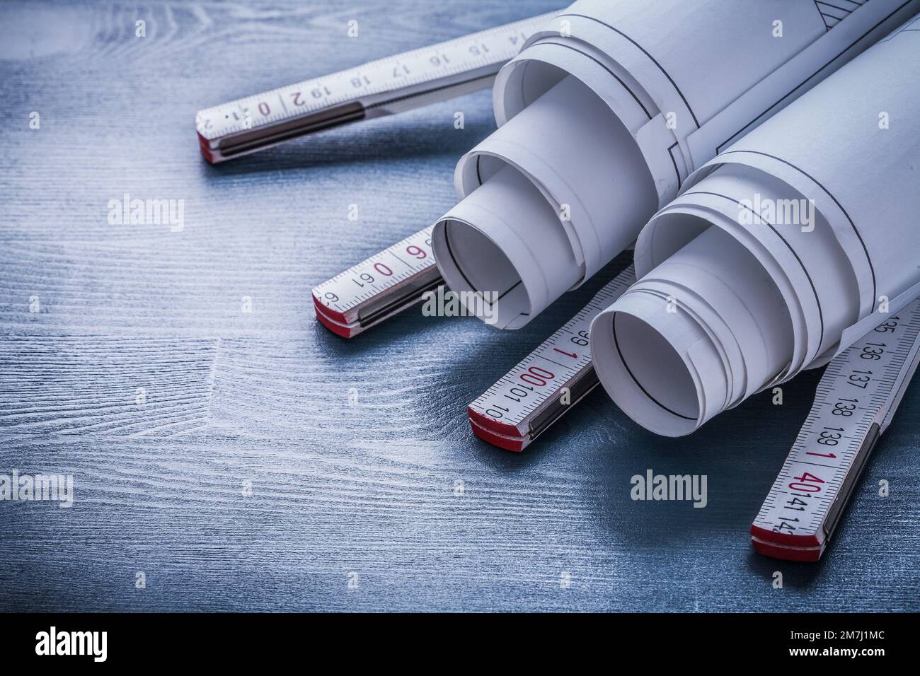 two rolls of blueprints on white wooden meter Stock Photo - Alamy